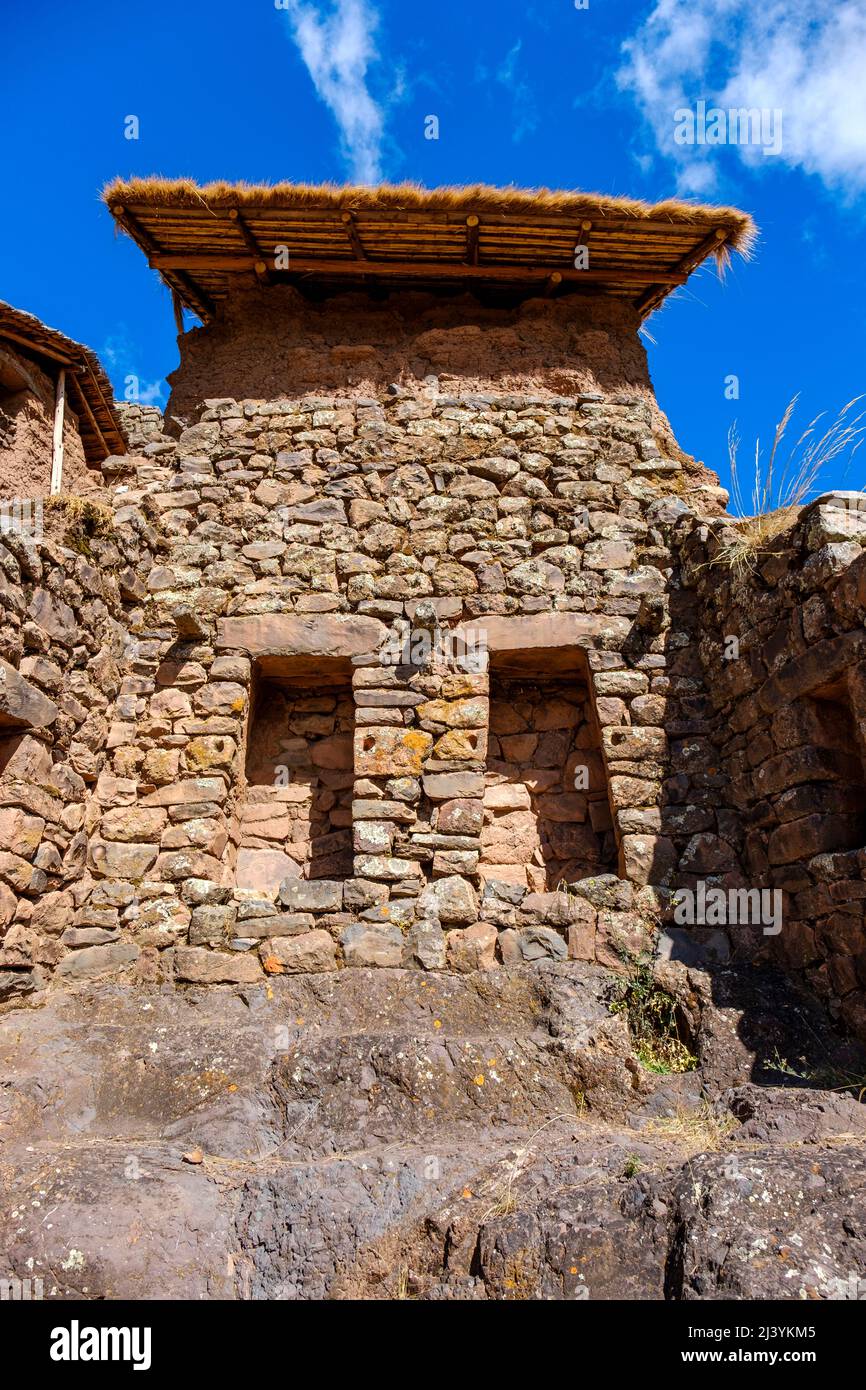 Inca construction showing stonework and thatched roof at Pisac Q ...