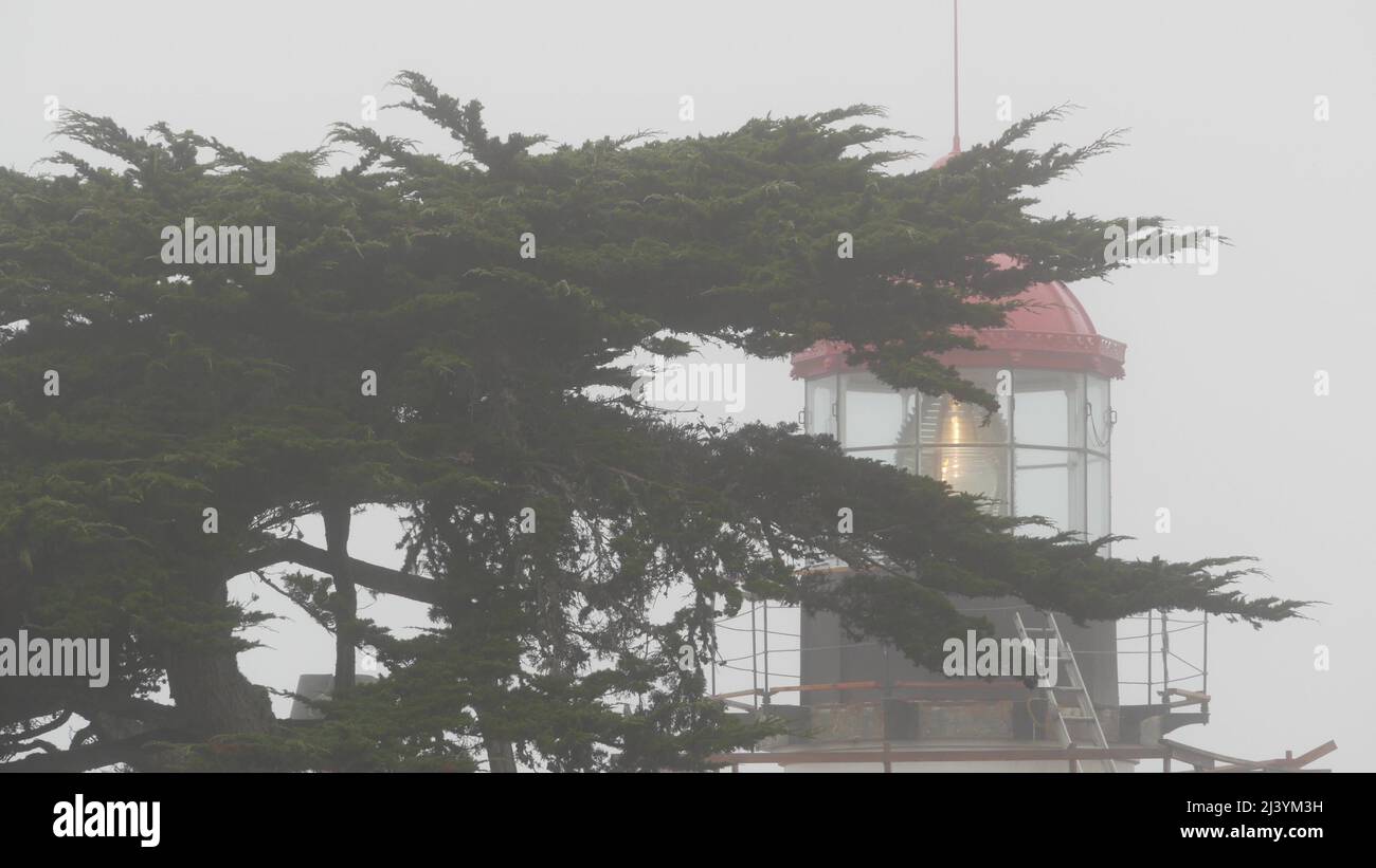 Point Pinos old historic lighthouse fresnel lens glowing, foggy rainy ...