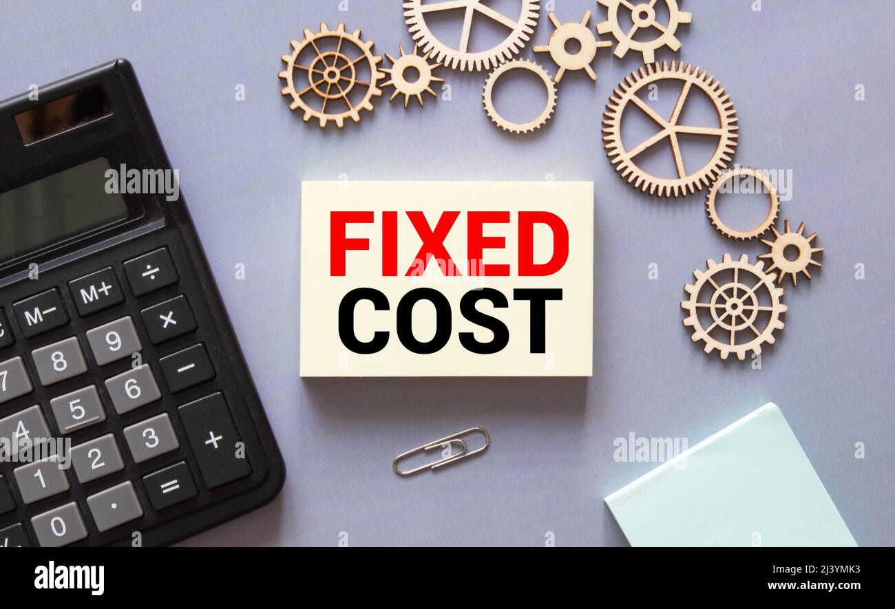 Fixed Cost . text on white notepad paper on a stand next to our desk ...