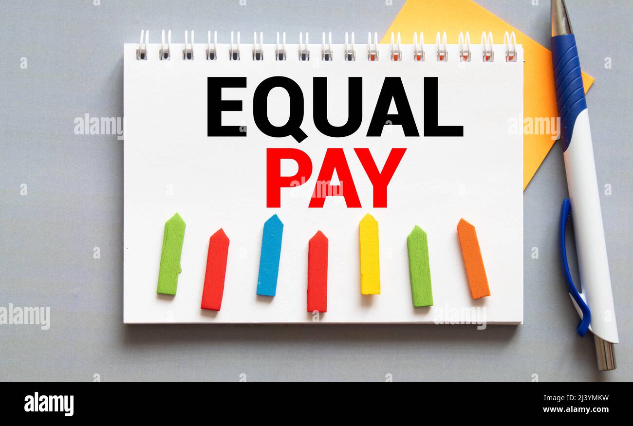 EQUAL PAY. text on white sheet of paper. against the background of ...