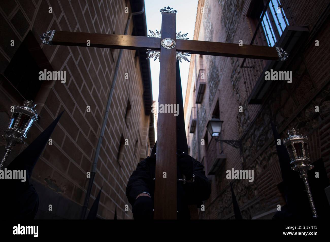A Nazarene carries a cross at the beginning of the procession of the ...