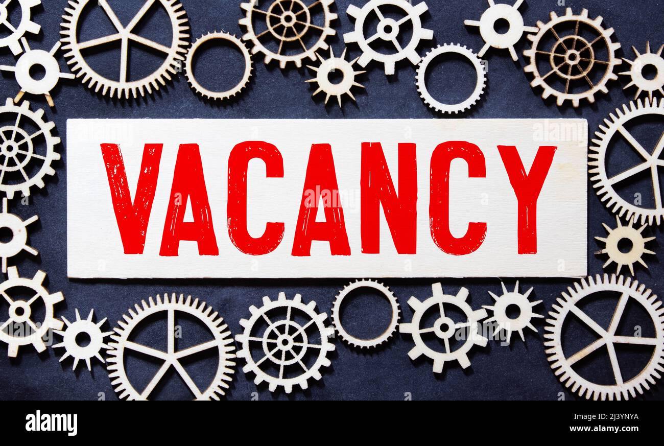 Vacancy word written on wood blocks on white grey background with ...