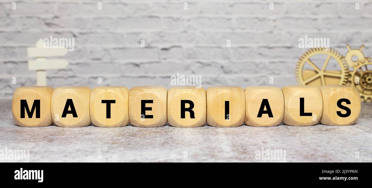 Material word on wooden block. Flat lay view on blue background Stock ...