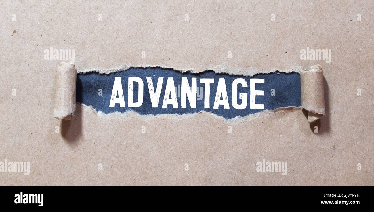 Advantage word on page and paper dollar signs around on wooden table ...