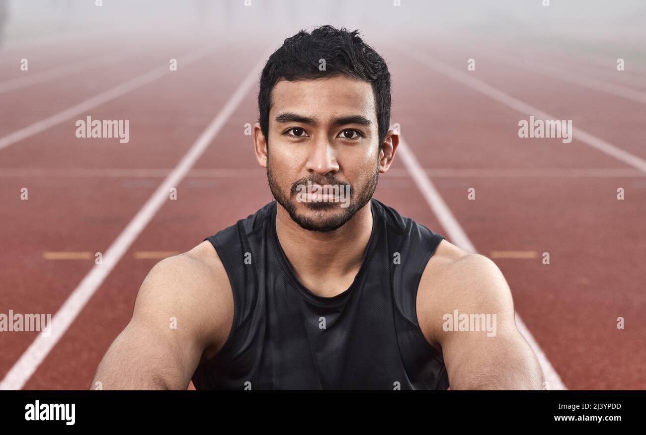 Determination always gets me that win. Shot of a young male athlete ...