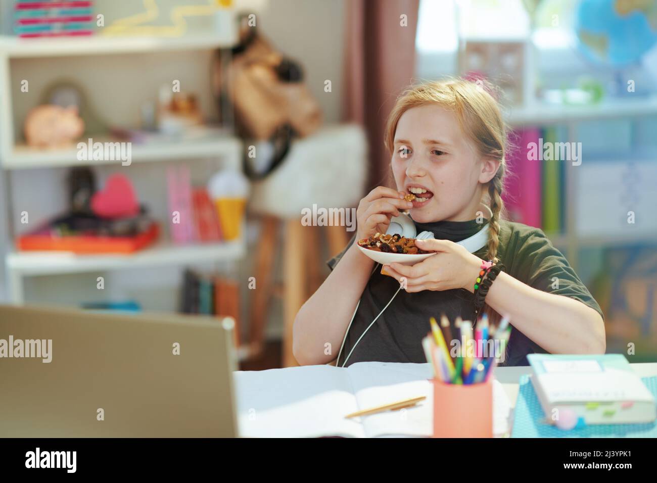 modern child in grey shirt with laptop and workbook distance learning ...