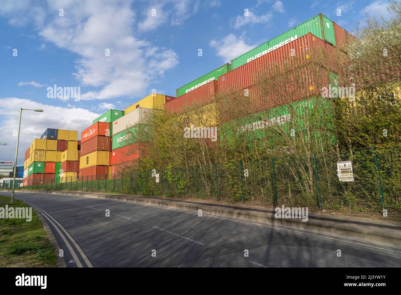 An international shipping company stacks their shipping container in ...