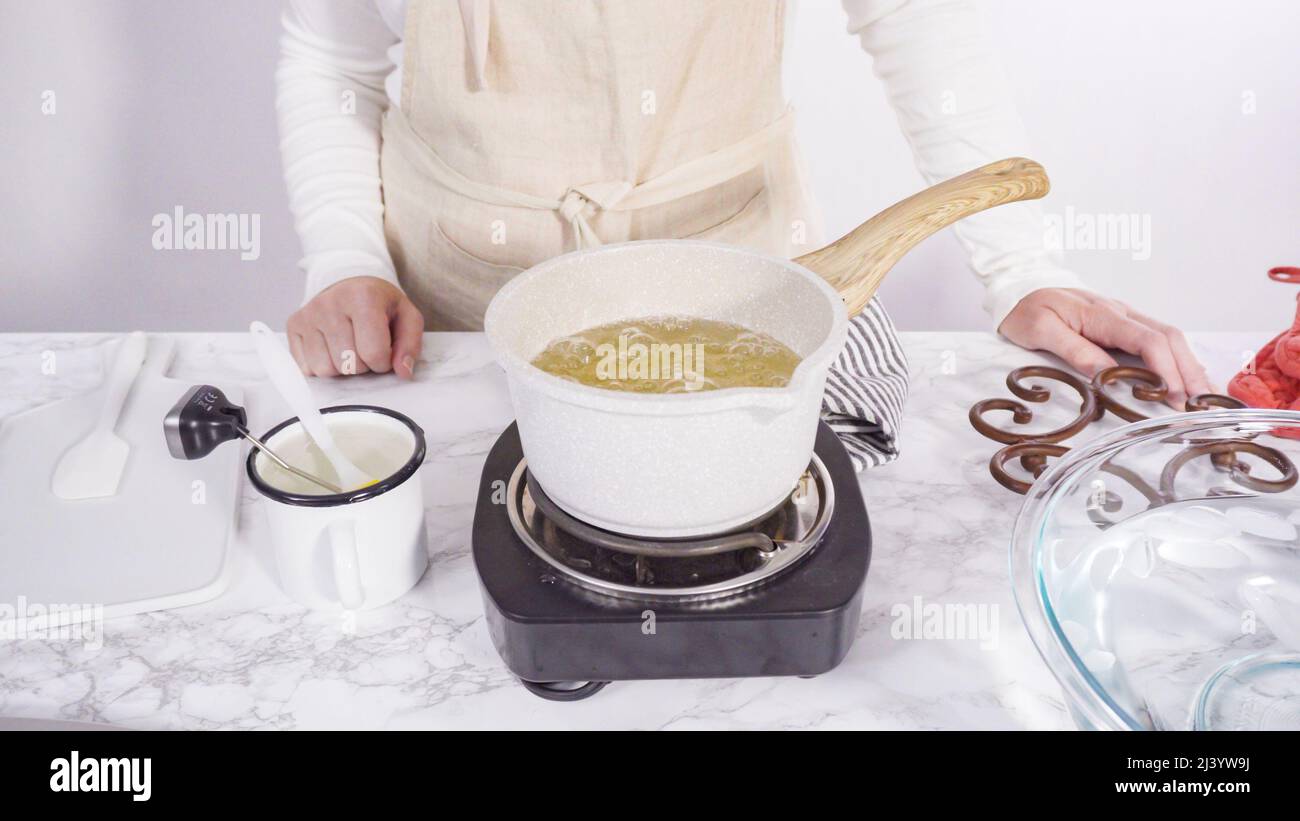 Step by step. Caramelizing sugar in a small cooking pot over the small ...