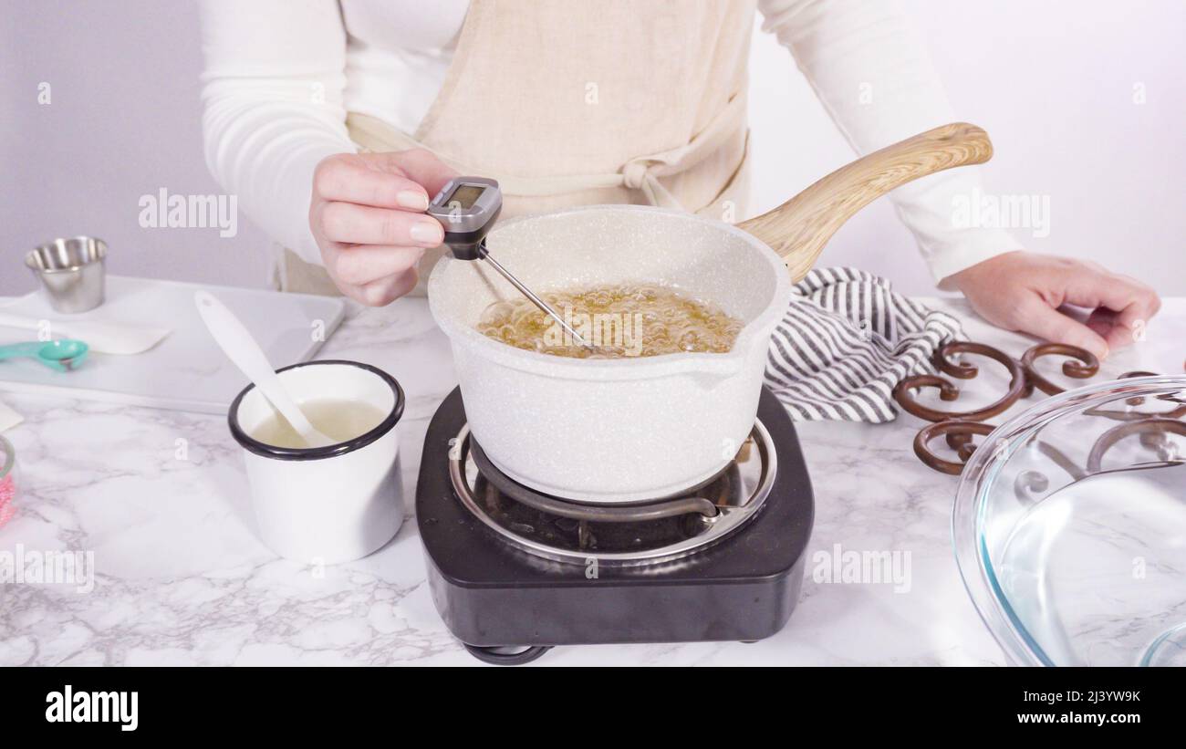 Step by step. Caramelizing sugar in a small cooking pot over the small ...