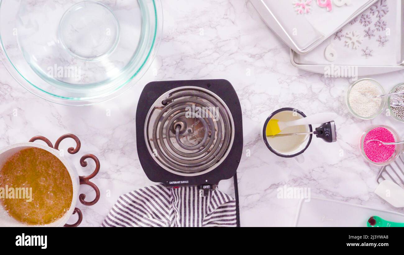 Flat lay. Step by step. Caramelizing sugar in a small cooking pot over ...