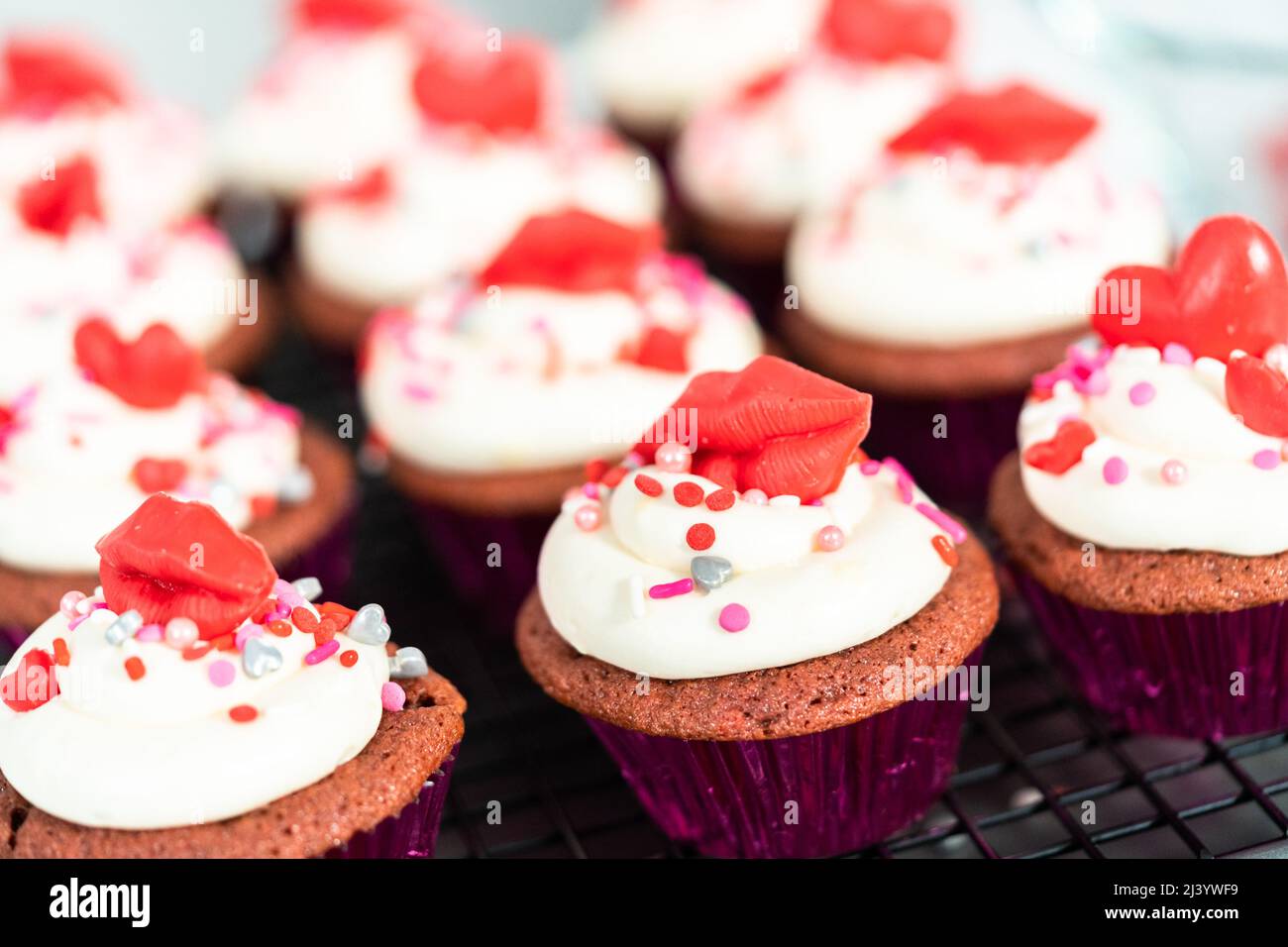 Red velvet cupcakes with cream cheese frosting and decorates with heart ...