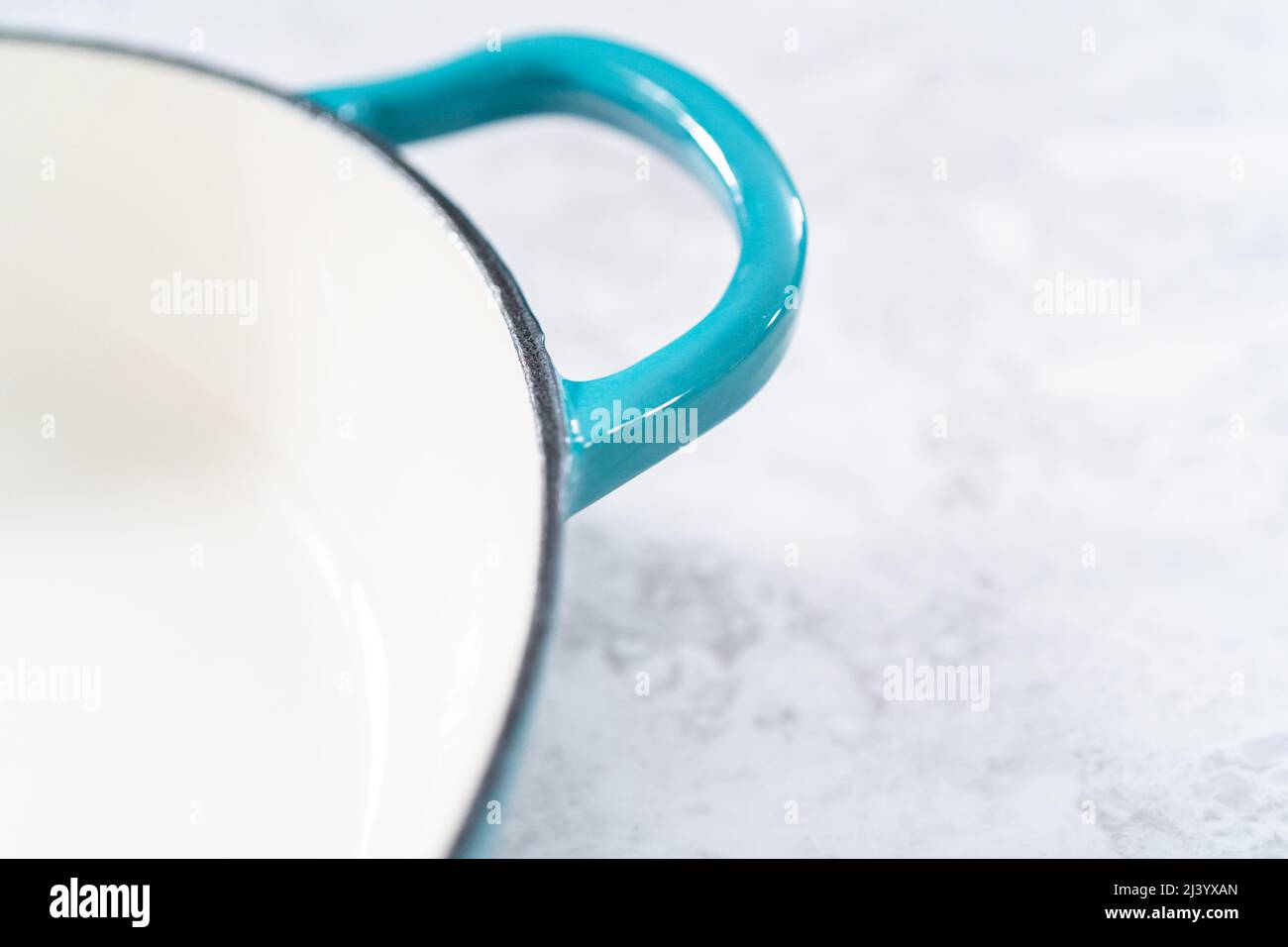 Clean cast iron enameled braiser on the kitchen counter Stock Photo - Alamy