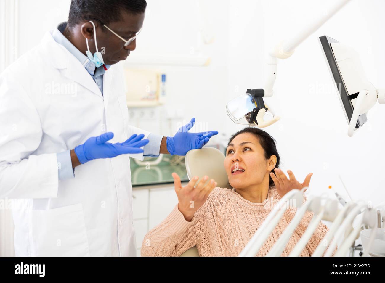 Woman talking with dentist about tooth problem in dental clinic Stock ...