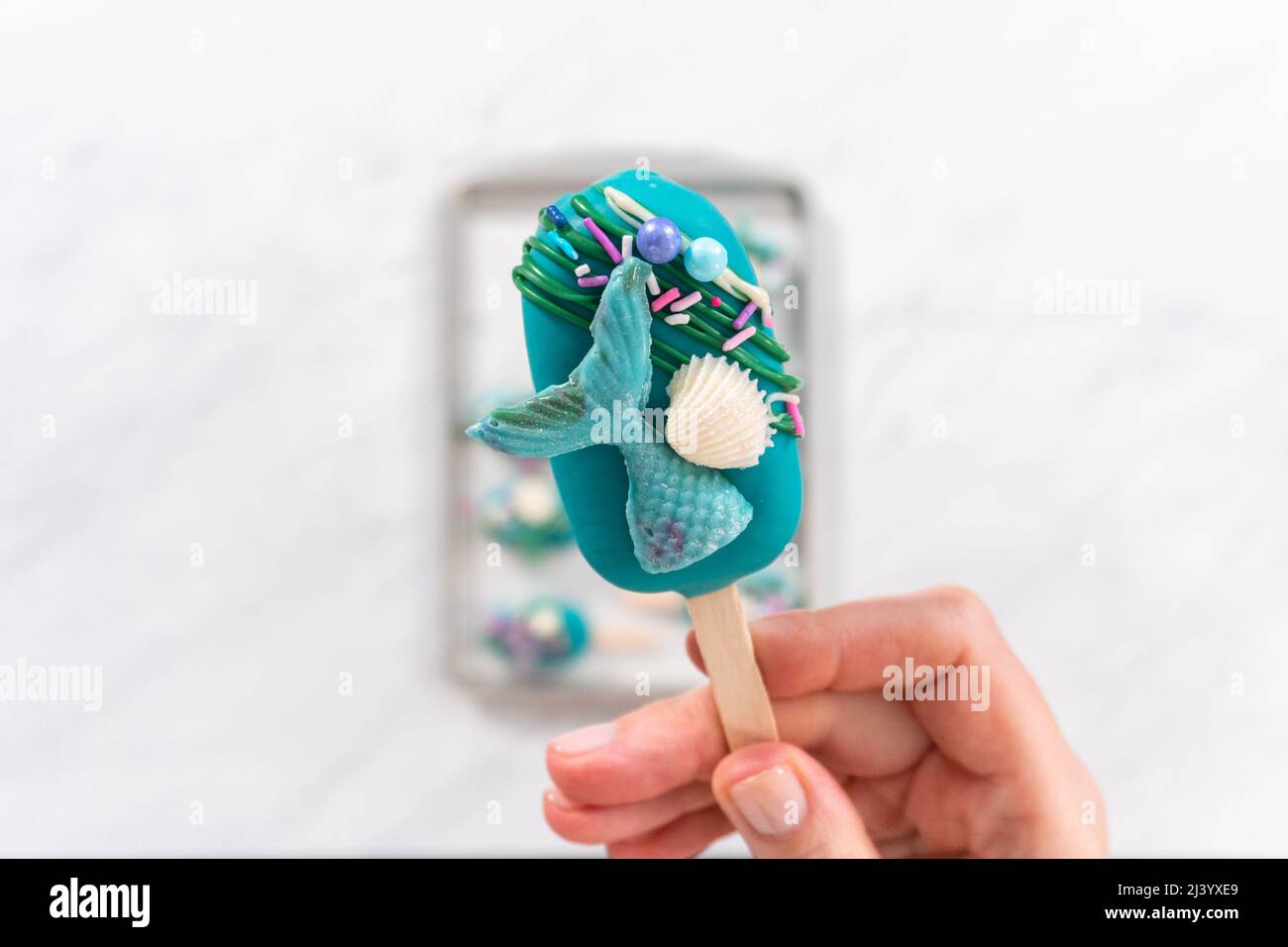 Flat lay. Mermaid cakesicles with drizzled chocolate, chocolate mermaid ...