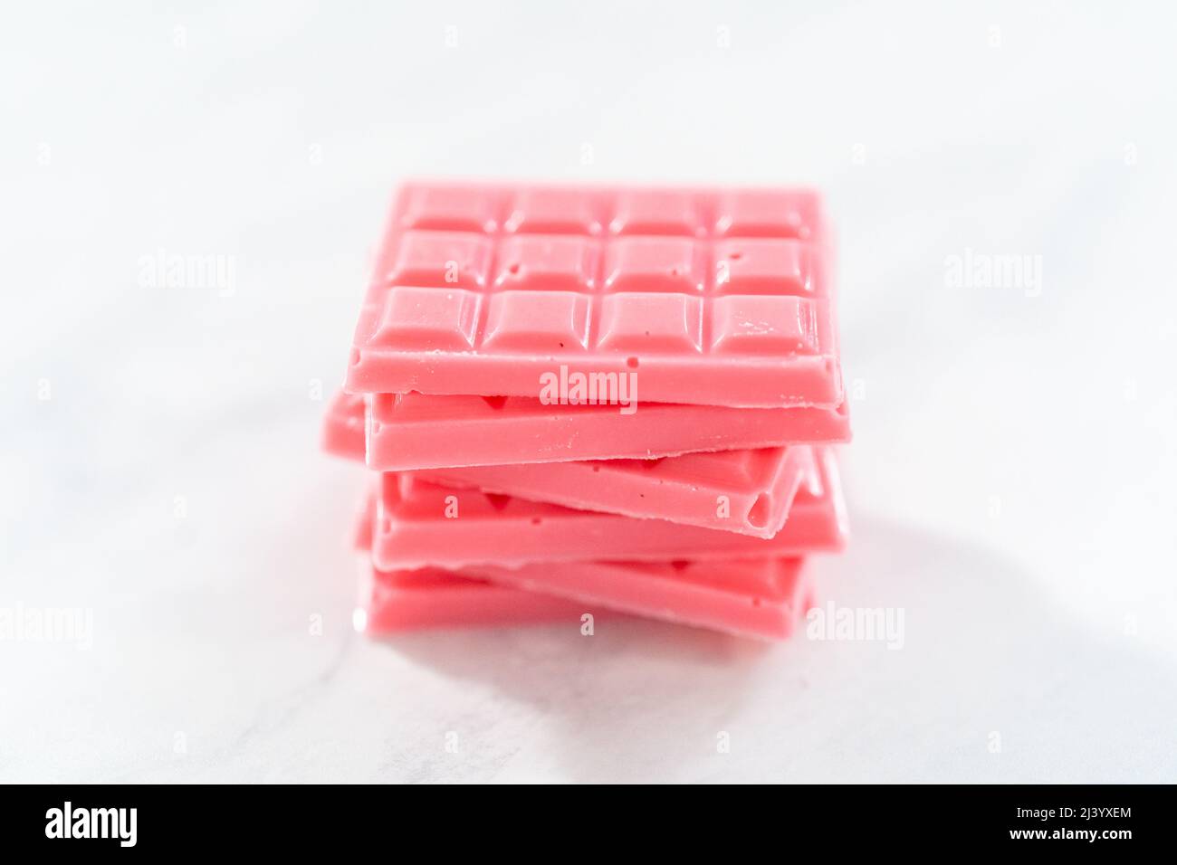Stack of homemade mini pink chocolates on the counter Stock Photo - Alamy