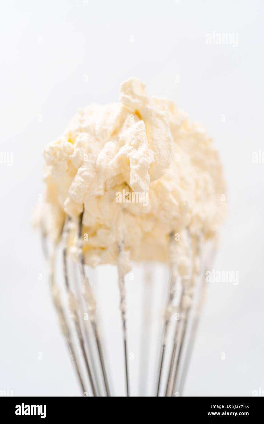 Whisk with homemade whipped cream. Freshly whipped Stock Photo - Alamy