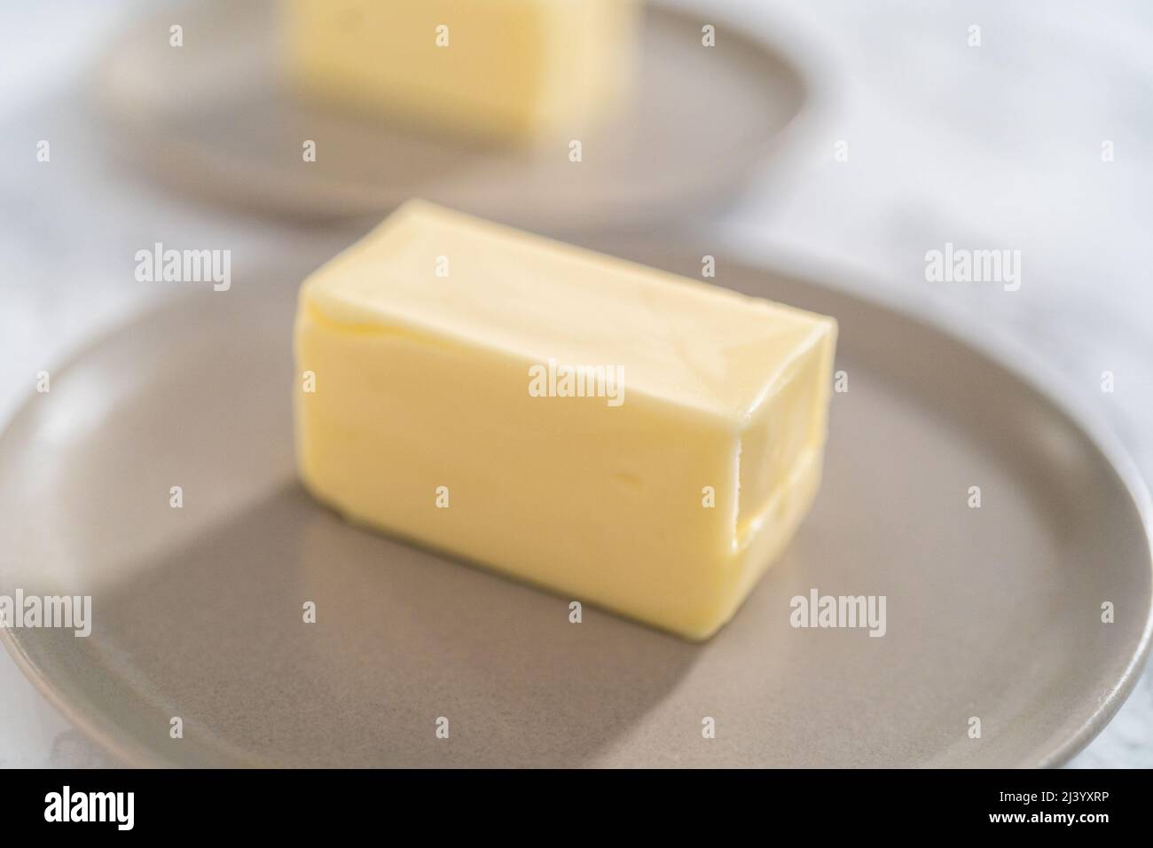 Sticks of unsalted butter on the small plates Stock Photo - Alamy