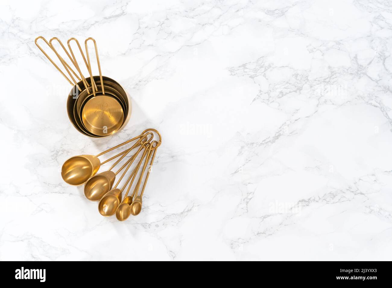 Flat lay. Cupper measuring cups and spoons for baking on a marble ...