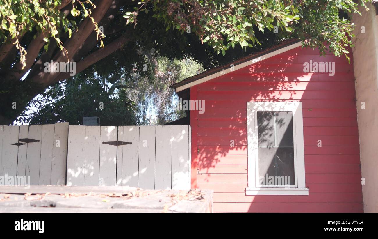Red wooden rural ranch house, rustic building exterior, window and gate ...