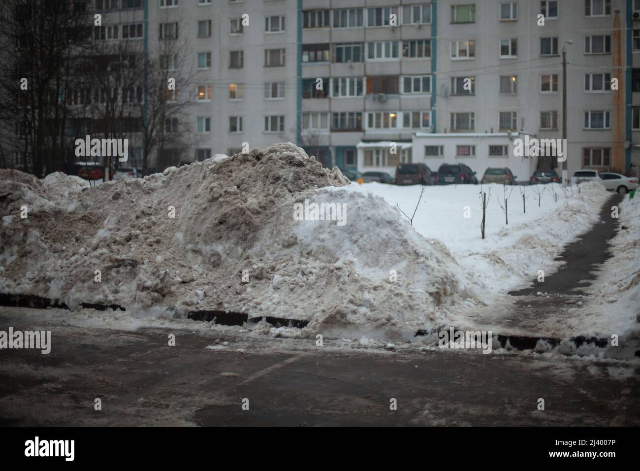 Snow in parking lot. Large snowdrift outside. Mountain of snow in yard ...
