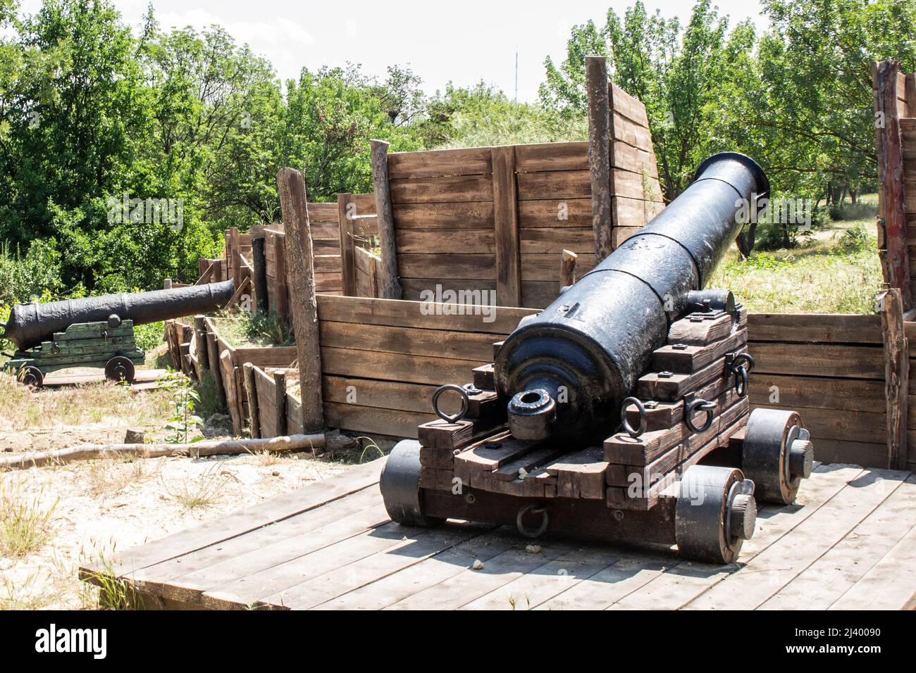Antique cannon with cannonballs. Defense of the city. Historic site ...