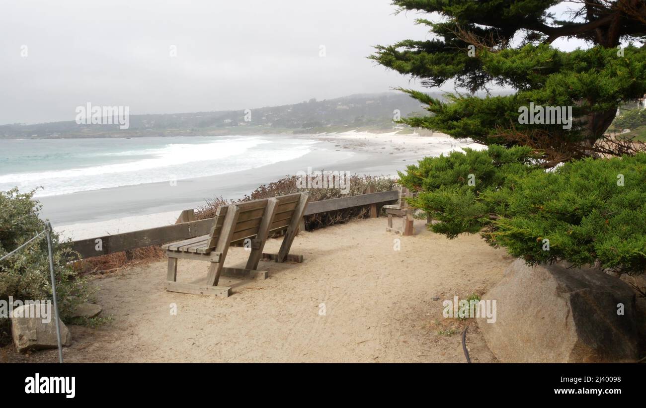 Empty wooden bench, rest on trail path, walkway or footpath. Carmel ...