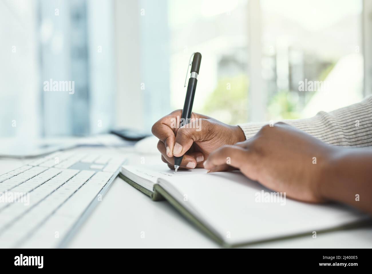 Write down your daily goals before you start each day. Cropped shot of ...