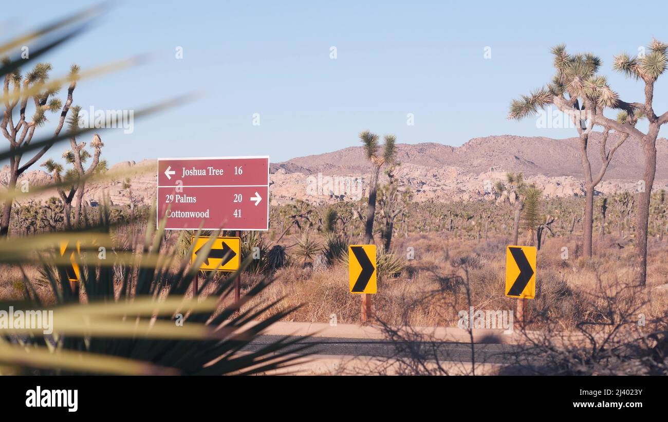 Crossroad sign with direction arrows on road intersection, California ...