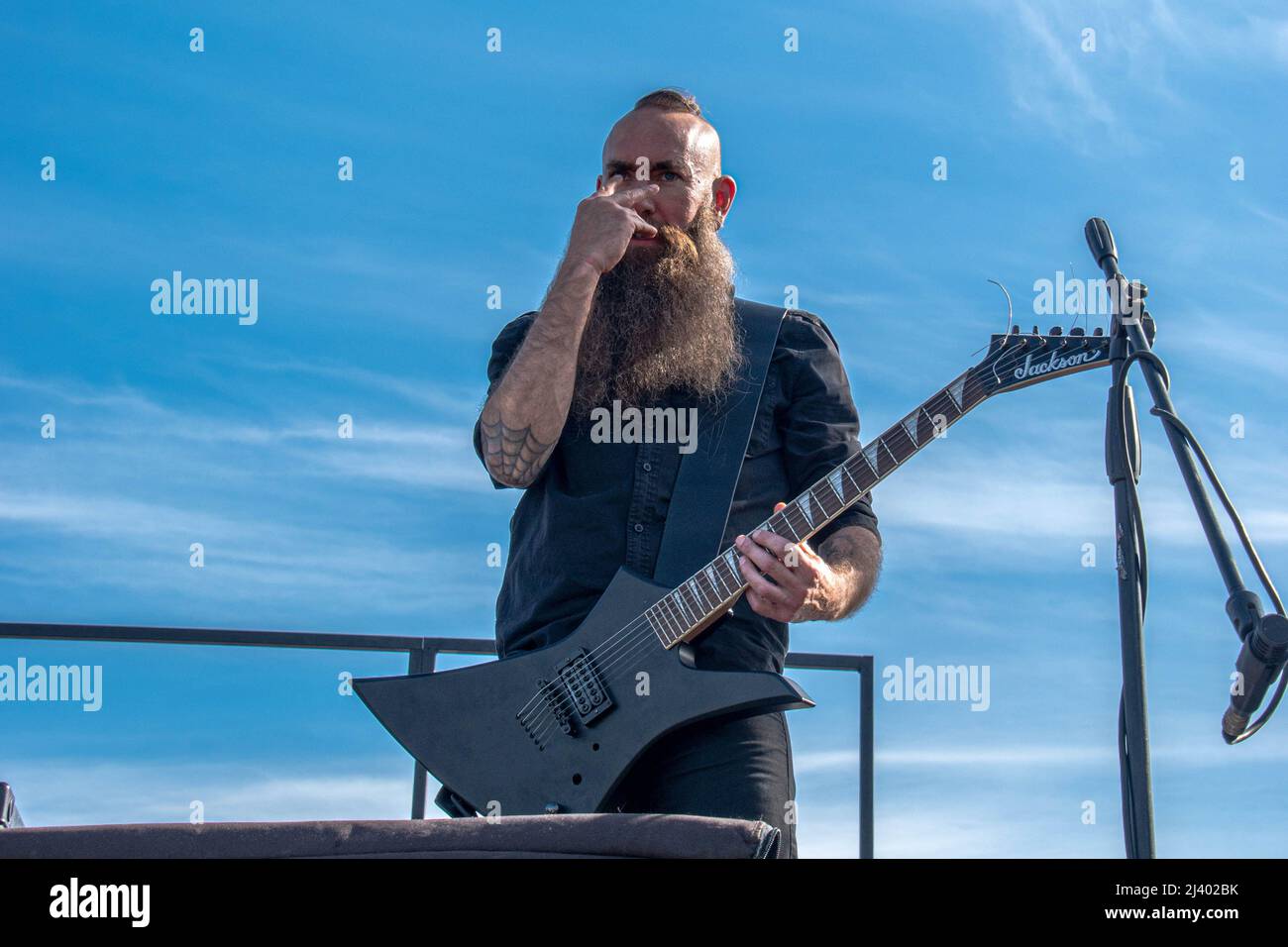 Beard rocker playing guitar and singing Stock Photo - Alamy