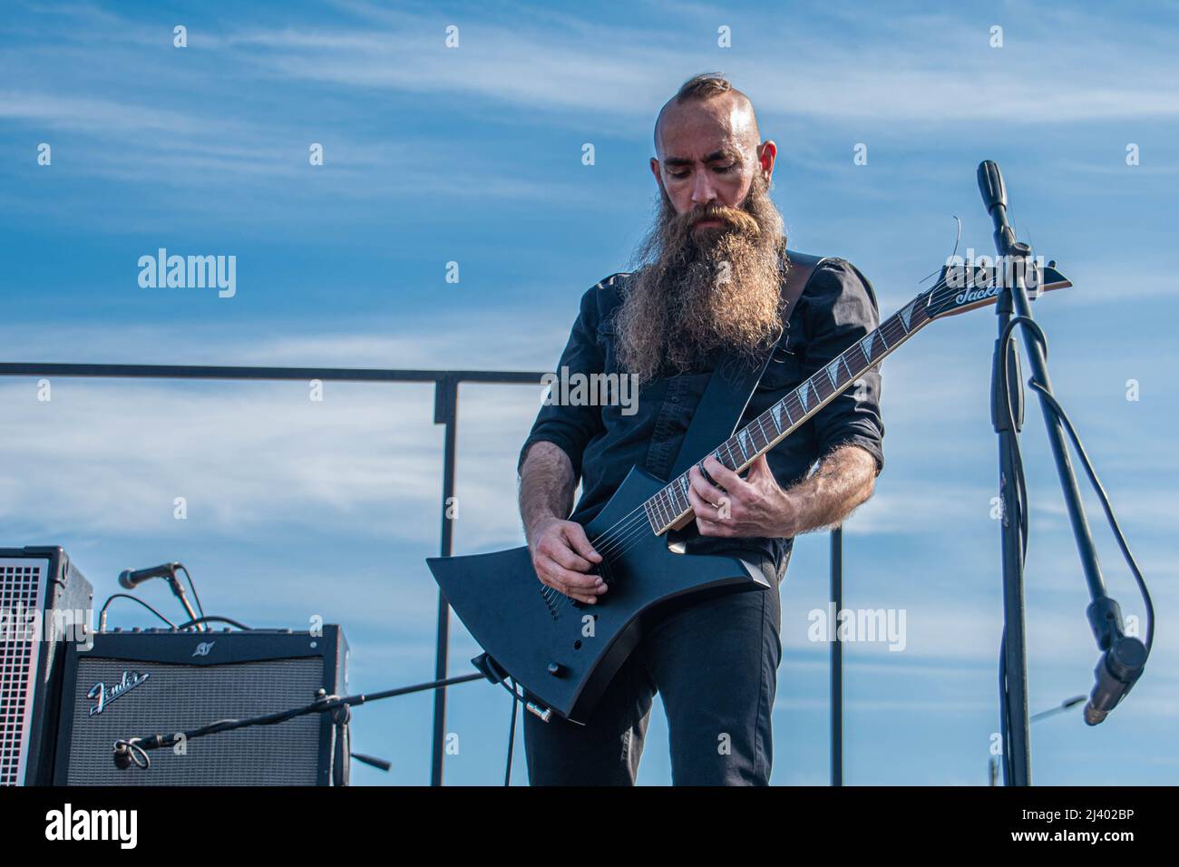 Beard rocker playing guitar and singing Stock Photo - Alamy