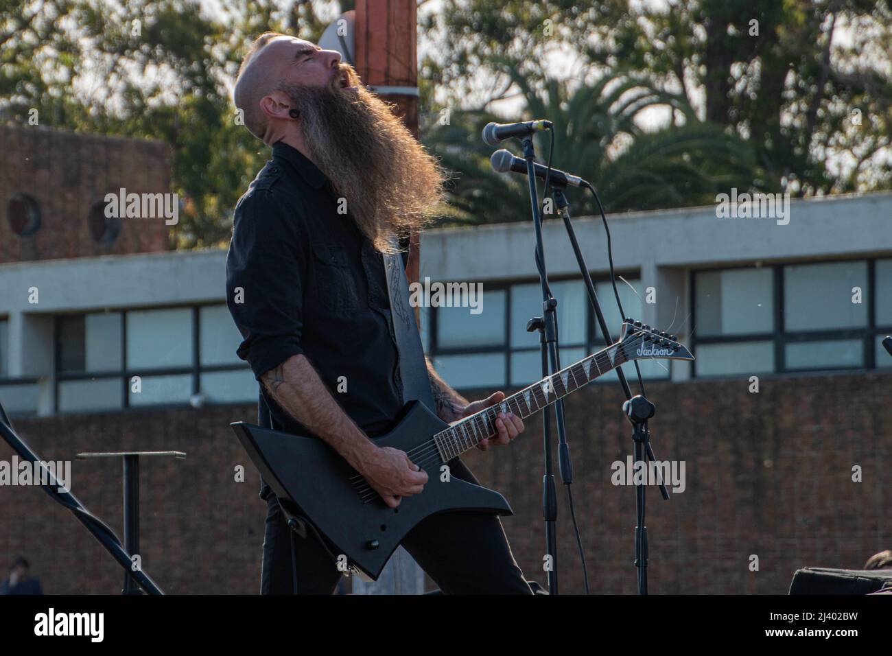 Beard rocker playing guitar and singing Stock Photo - Alamy