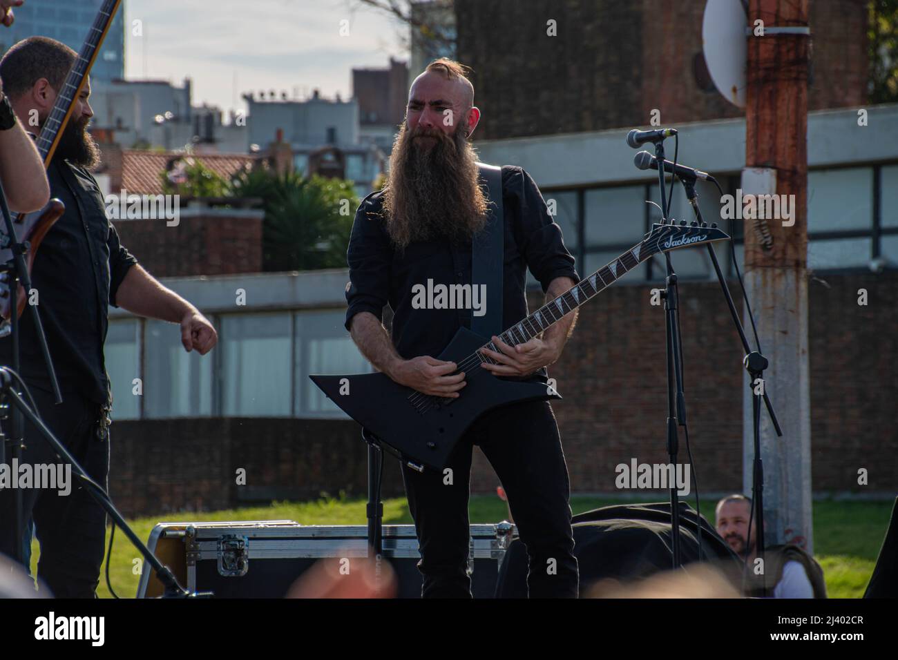 Beard rocker playing guitar and singing Stock Photo - Alamy