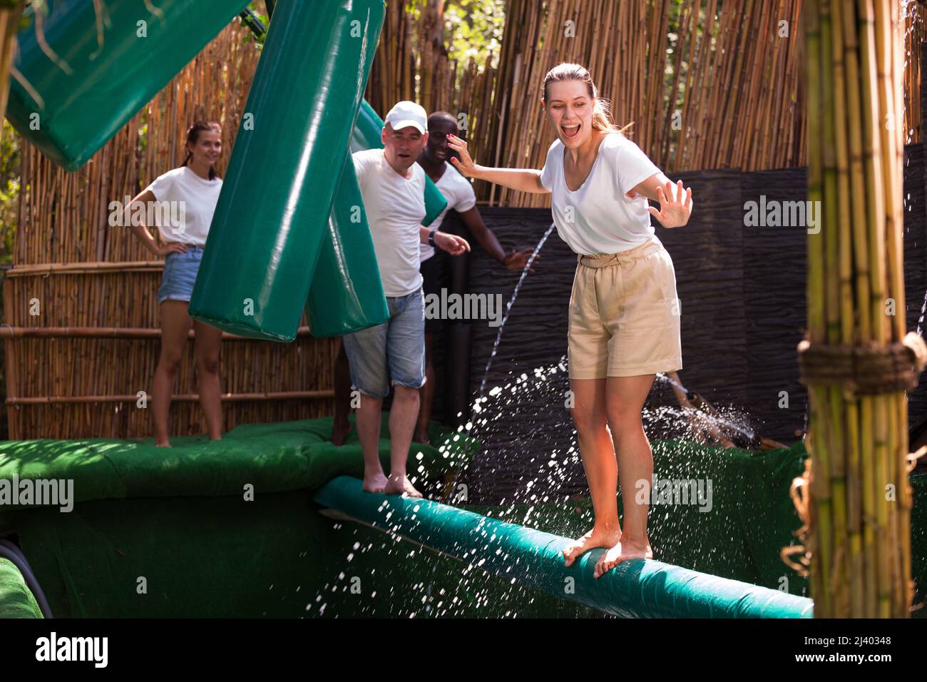 People trying to pass crossbar Stock Photo - Alamy