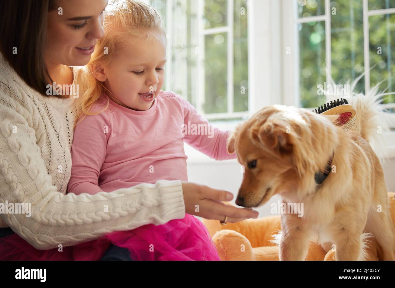 Its your pamper day. Shot of a little girl sitting on her mothers lap ...