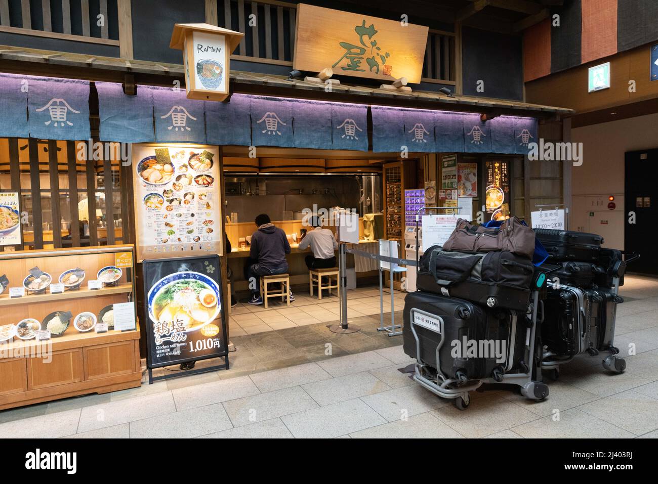 Travelers are seen eating inside a ramen restaurant inside Terminal 3 ...