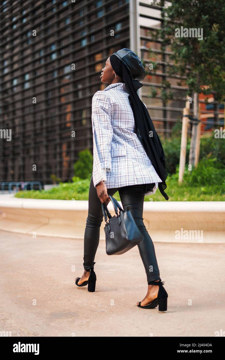Back view full body of African American female in trendy outfit with ...
