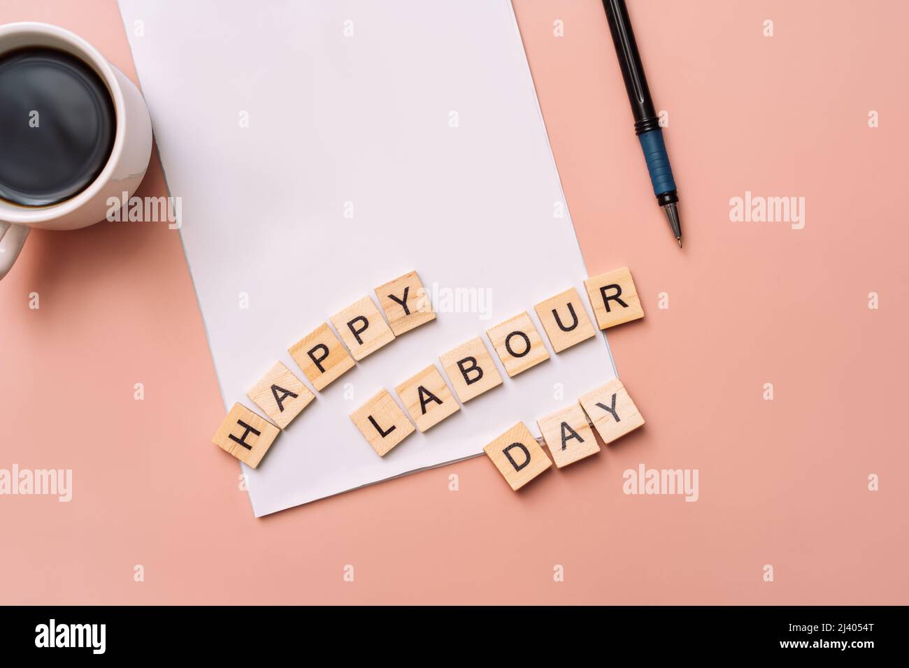 Words happy labor day are laid out on paper next to cup and pen Stock ...