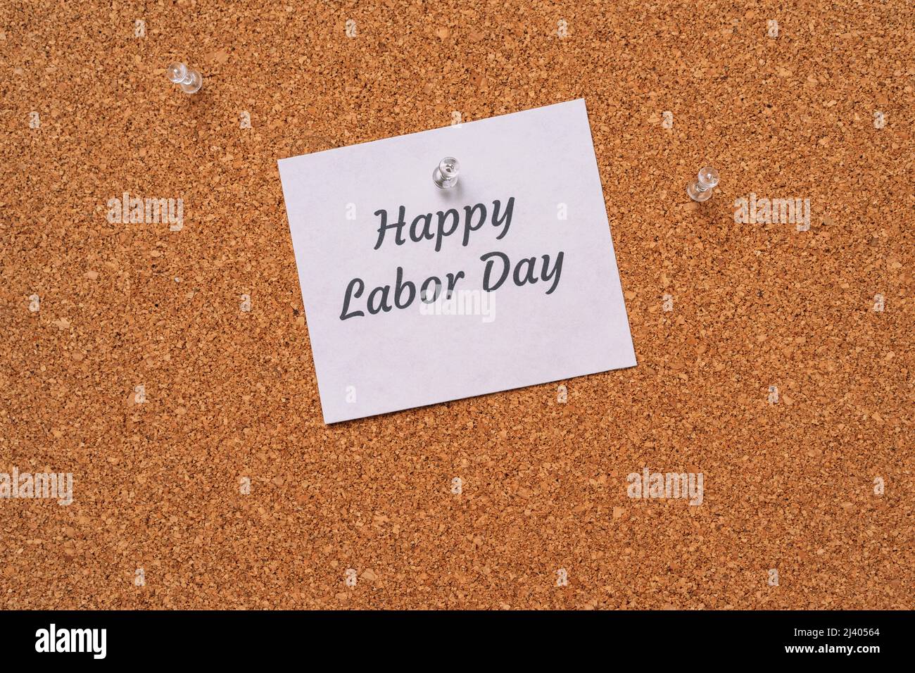 Happy labor day sticker nailed to chalkboard Stock Photo - Alamy