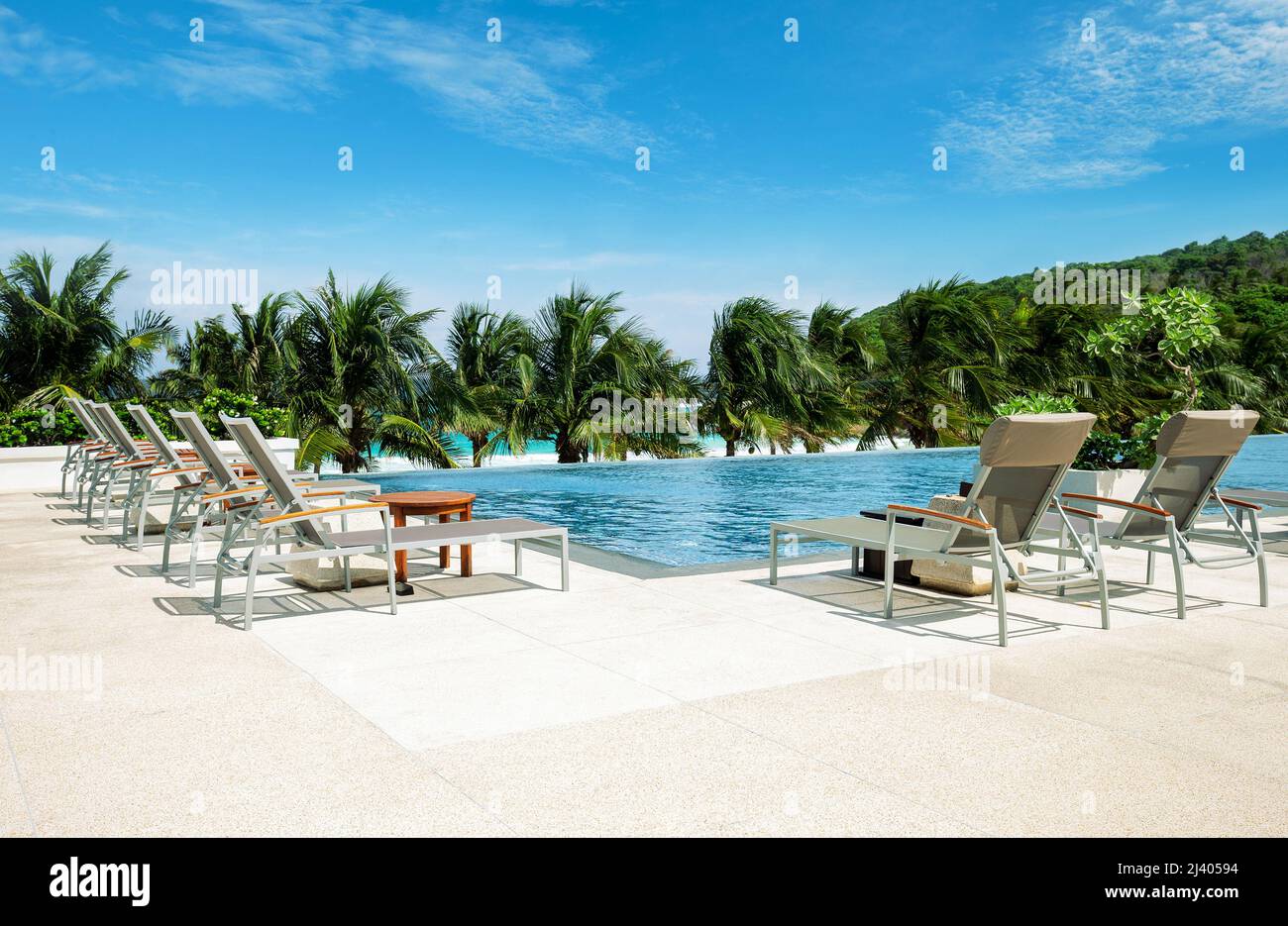 Swimming pool in tropical resort Stock Photo - Alamy