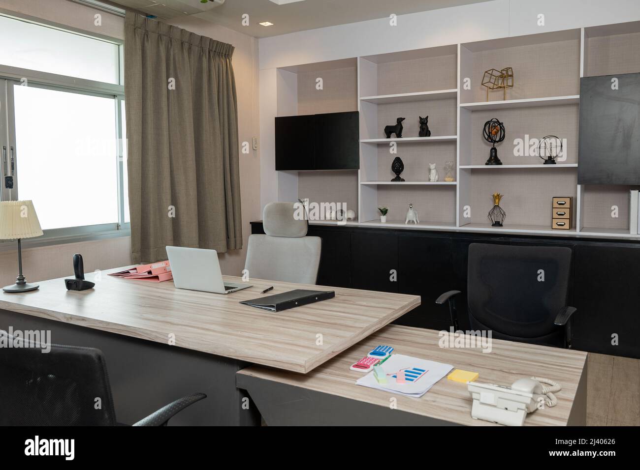 Comfortable office chair near wooden table with laptop computer ...