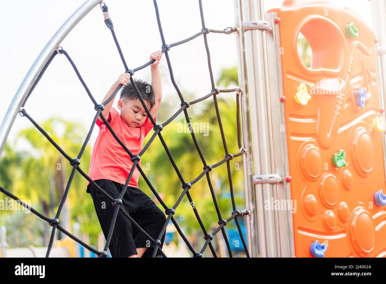 Asian child smiling playing climbing outdoor playground, happy ...