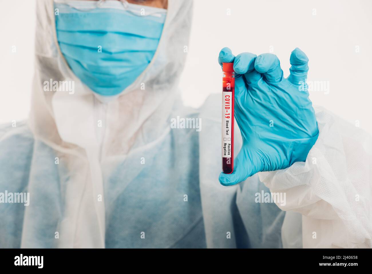 Medical scientist in PPE uniform wear a mask holding test tube ...