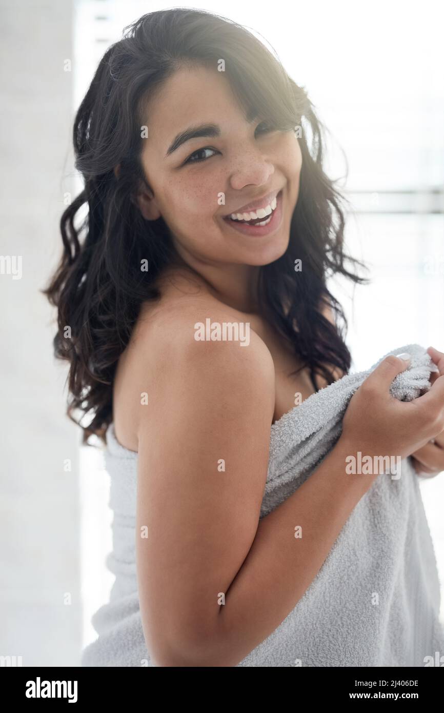 Starting my day off all fresh and clean. Portrait of an attractive young woman wrapped in a ...