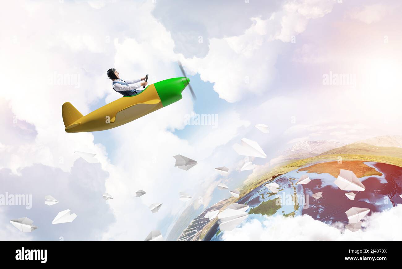 Aviator in leather helmet driving small plane Stock Photo - Alamy