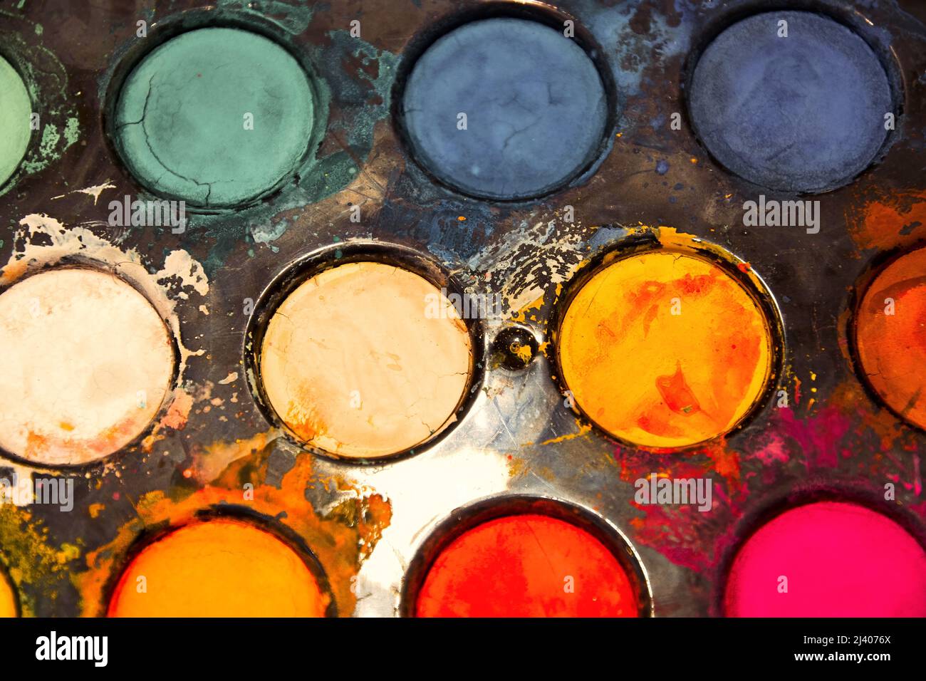 Black paints palette with colorful dry paints and color splashing. Arts ...