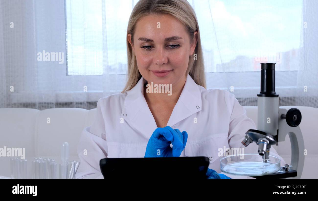 Woman scientist research chemist in a medical suit and protective ...