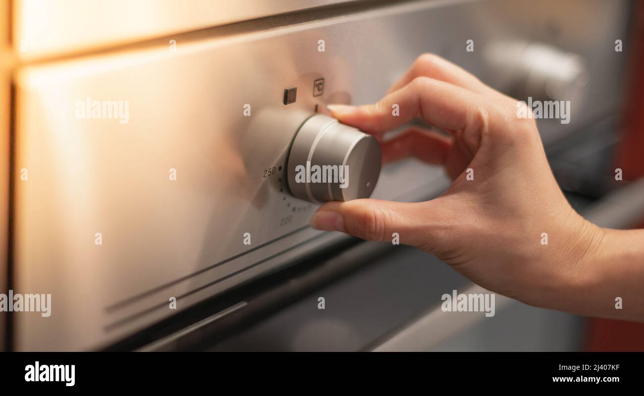 Close up female hand Opening Or Closing modern electric oven prepare to ...
