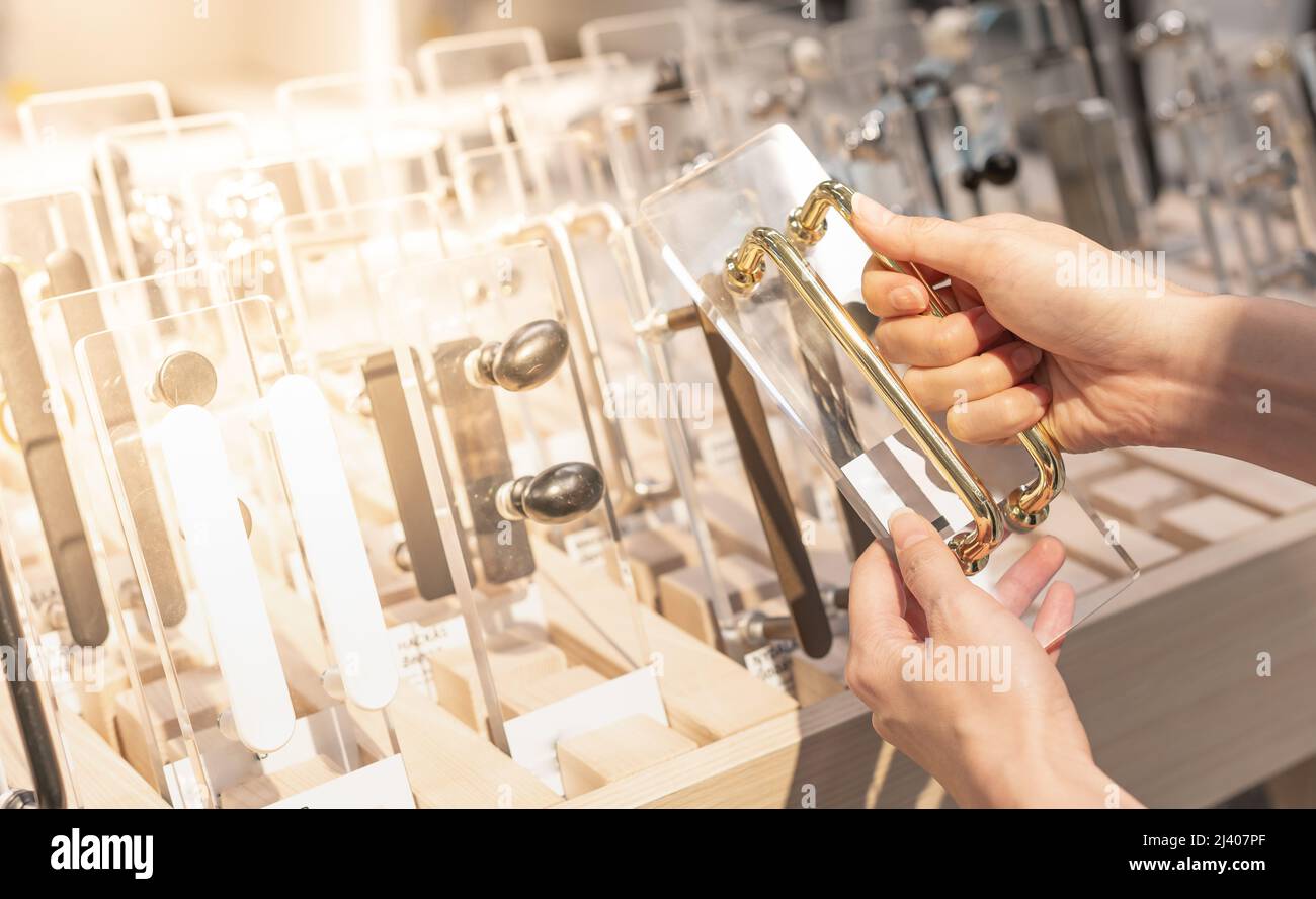 Female hand choosing the stainless handing door, the part of the door ...