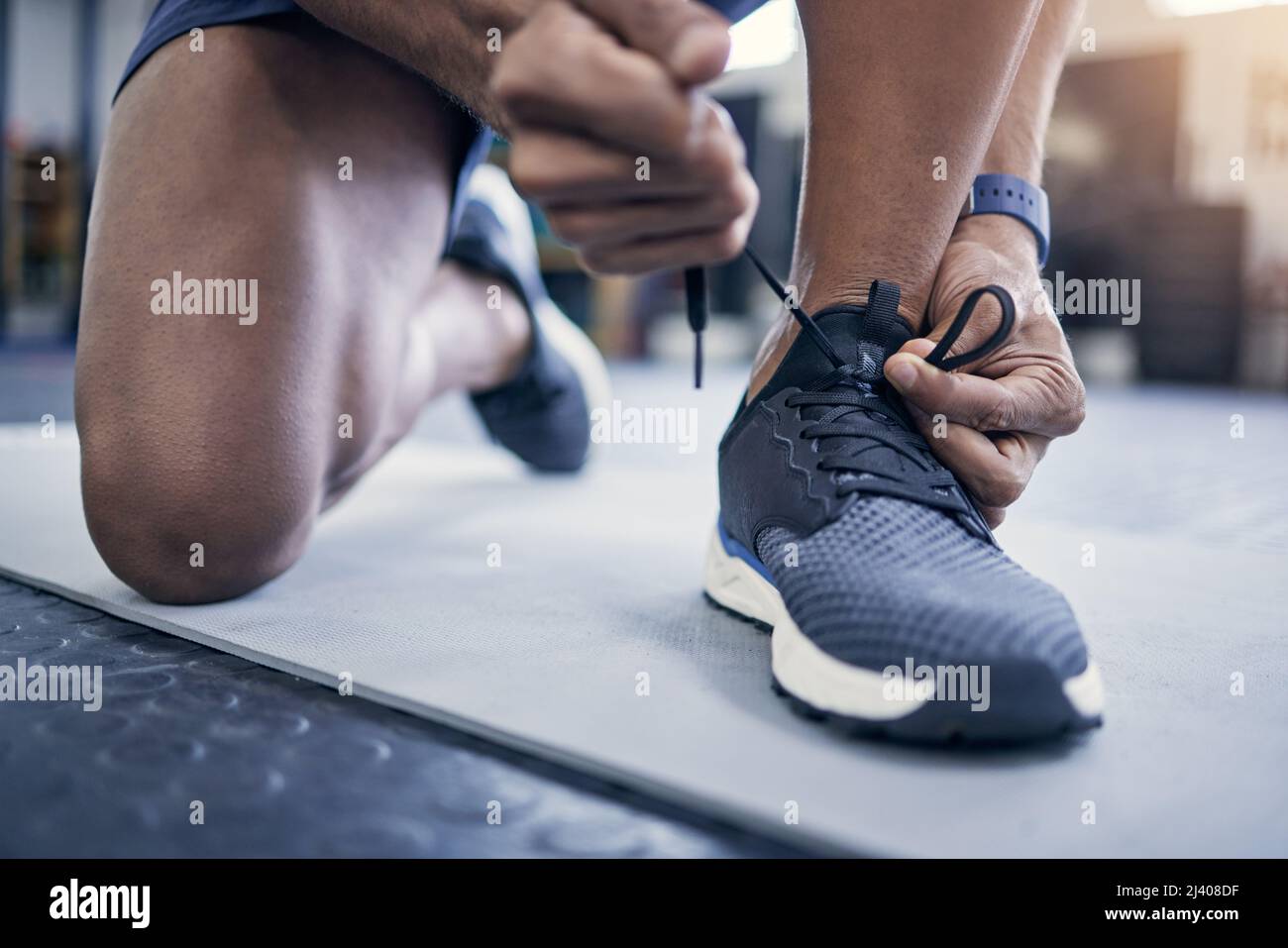 Lace up for a good workout. Closeup shot of an unrecognisable man tying ...