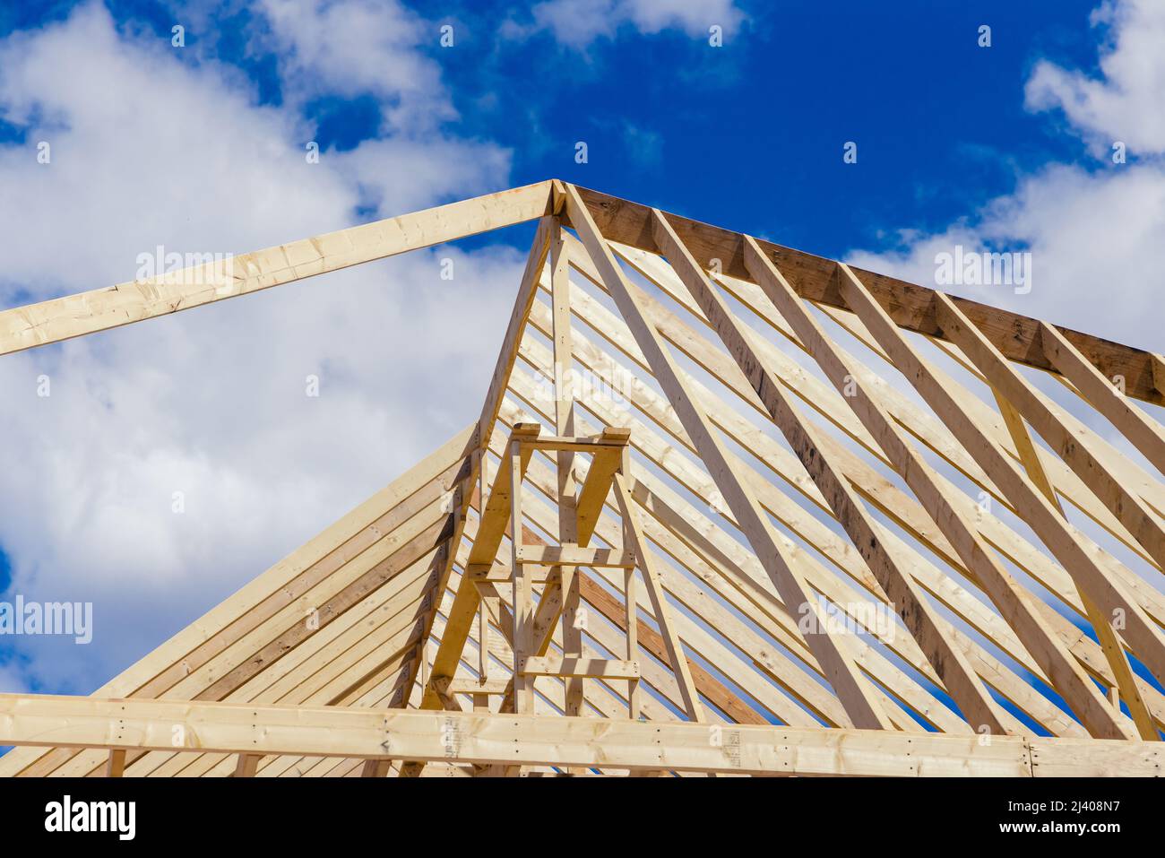 Newly built wooden skeleton frame of house roof section view in ...